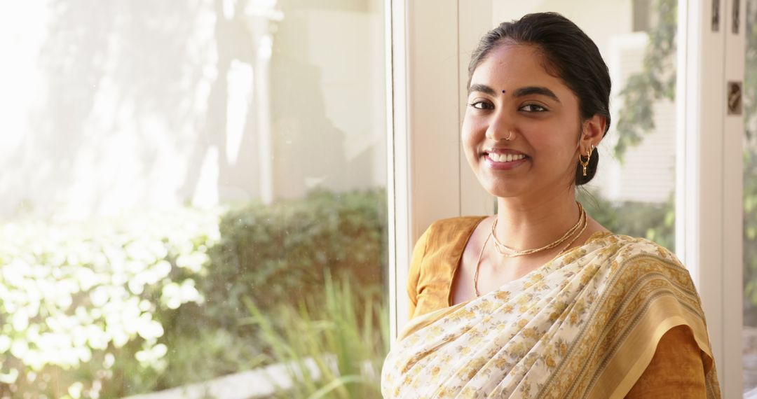 Confident Indian Woman Smiling in Traditional Sari by Sunlit Window ...