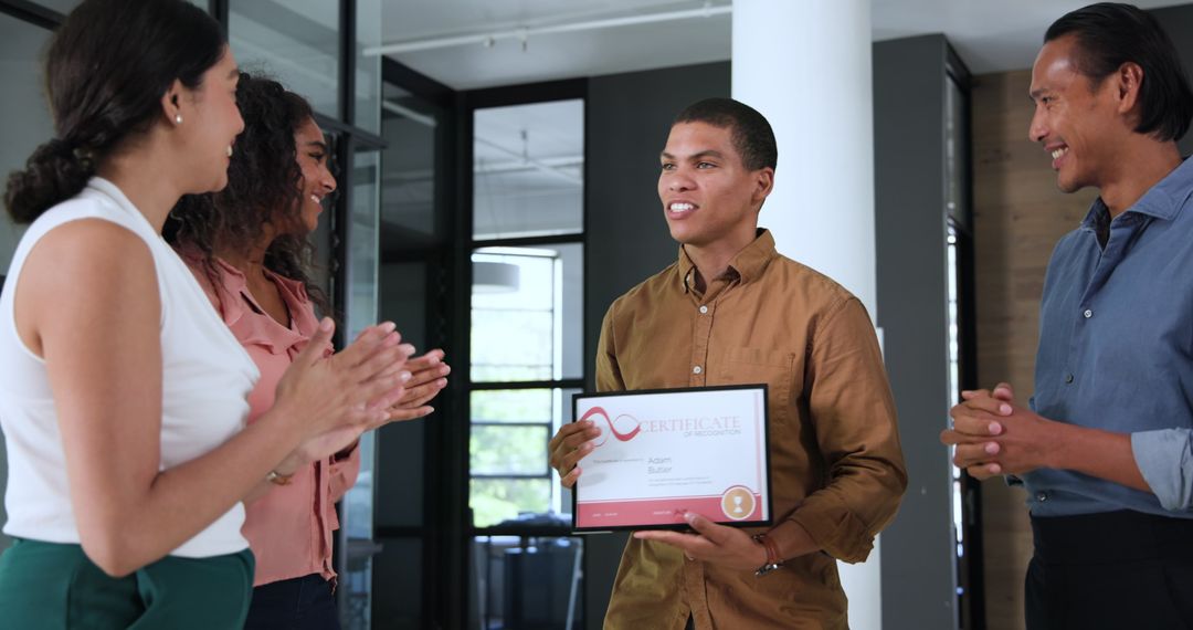 celebrating employee achievement with team recognition in office - Free ...