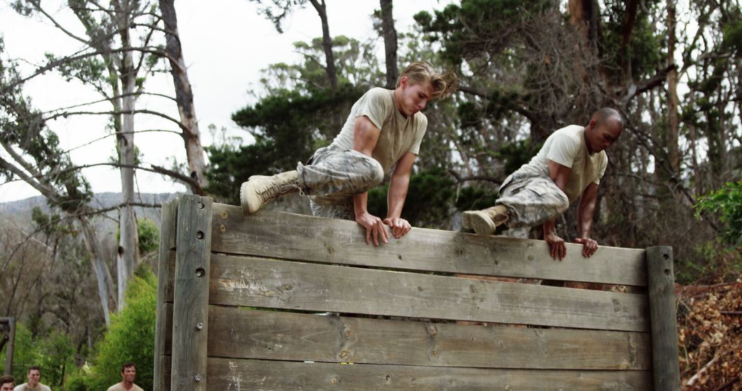 Determined Soldiers Climbing Wall in Outdoor Obstacle Course - Free ...