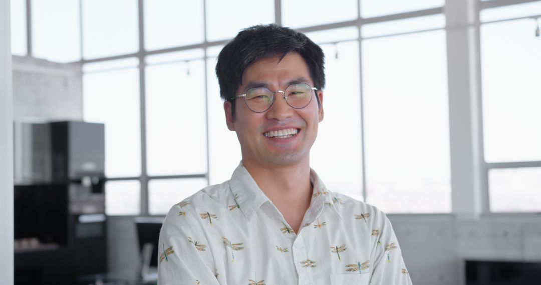 Confident asian male executive smiling in modern office environment ...