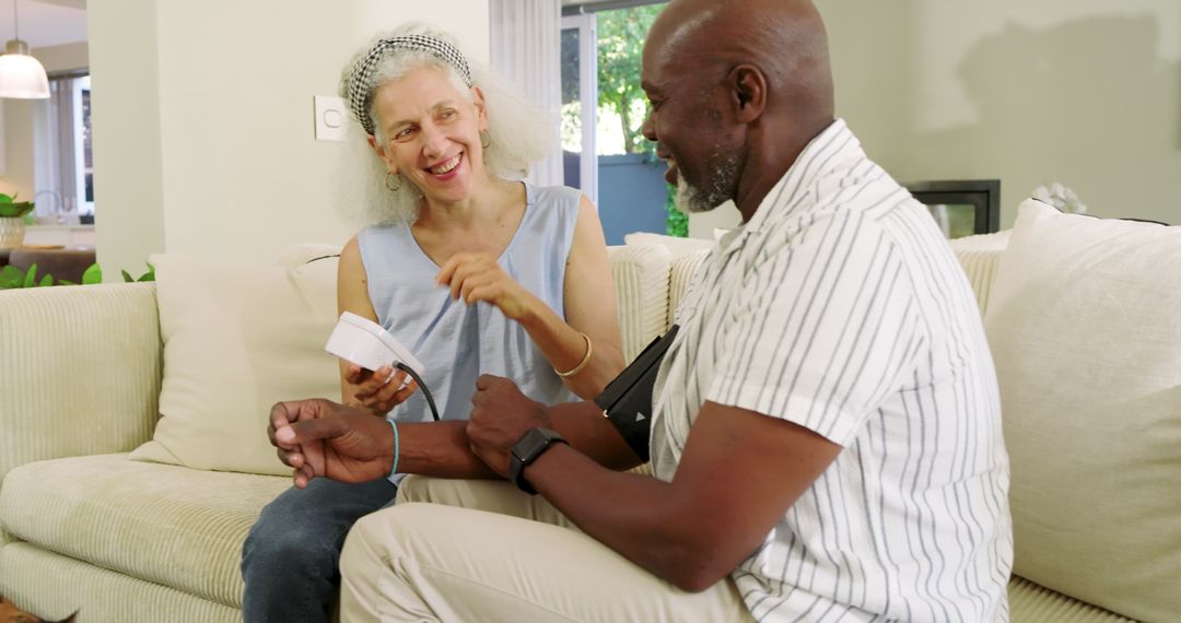 Senior Couple Measuring Blood Pressure at Home with Monitor Device ...