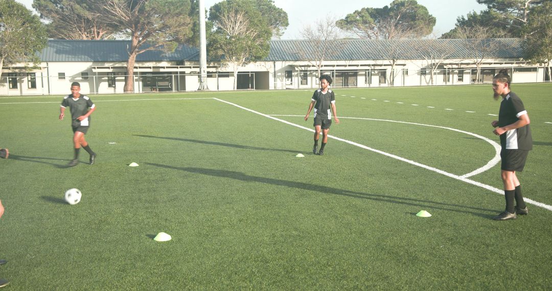 Teen soccer players practicing passing drills on school field - Free ...