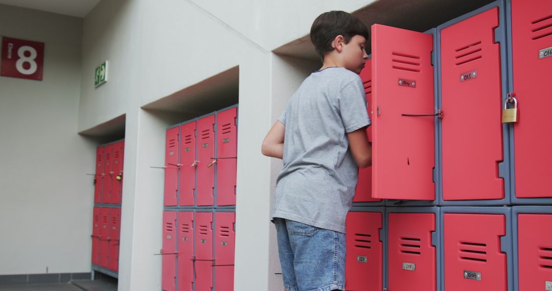 Boy Organizing Locker in School Hallway - Free Stock Photo | Pikwizard