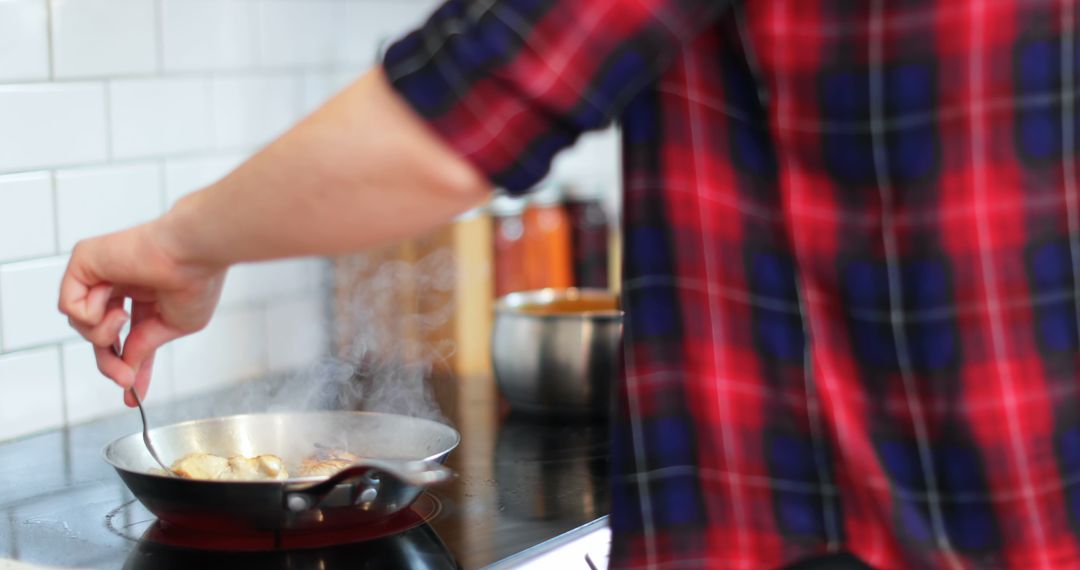 Home cook stirring delicious meal on modern stove - Free Stock Photo ...
