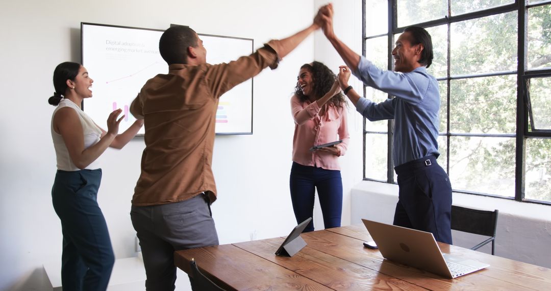 Cheerful diverse team celebrates success in modern office - Free Stock ...