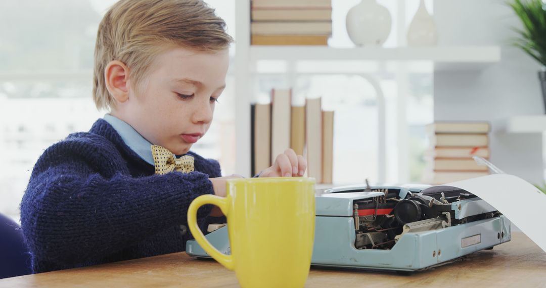 Young Boy Typing on Vintage Typewriter in Modern Workspace - Download ...