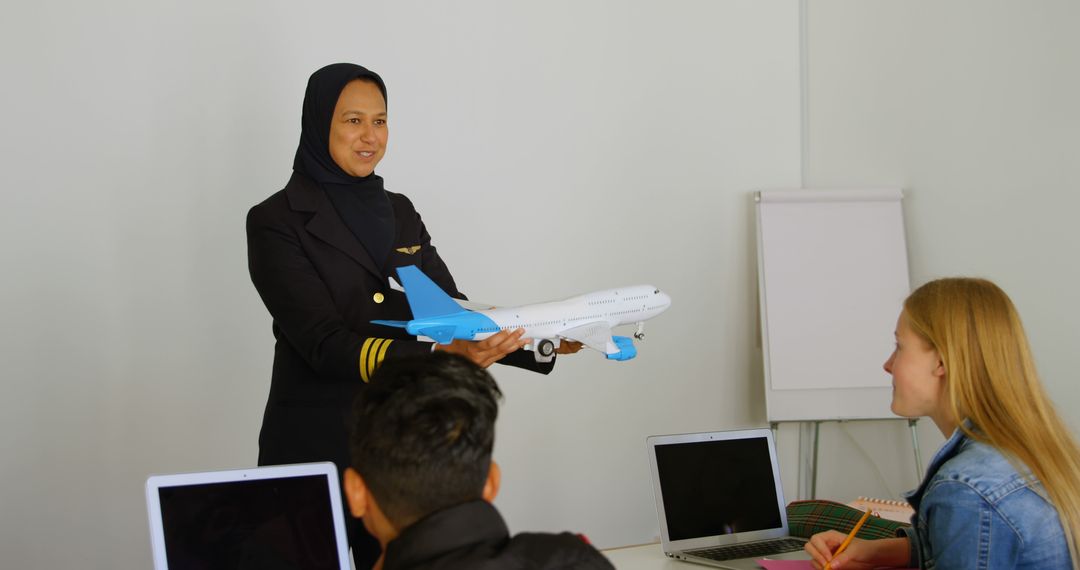 Confident Female Pilot Teaching Students About Aviation with Model ...