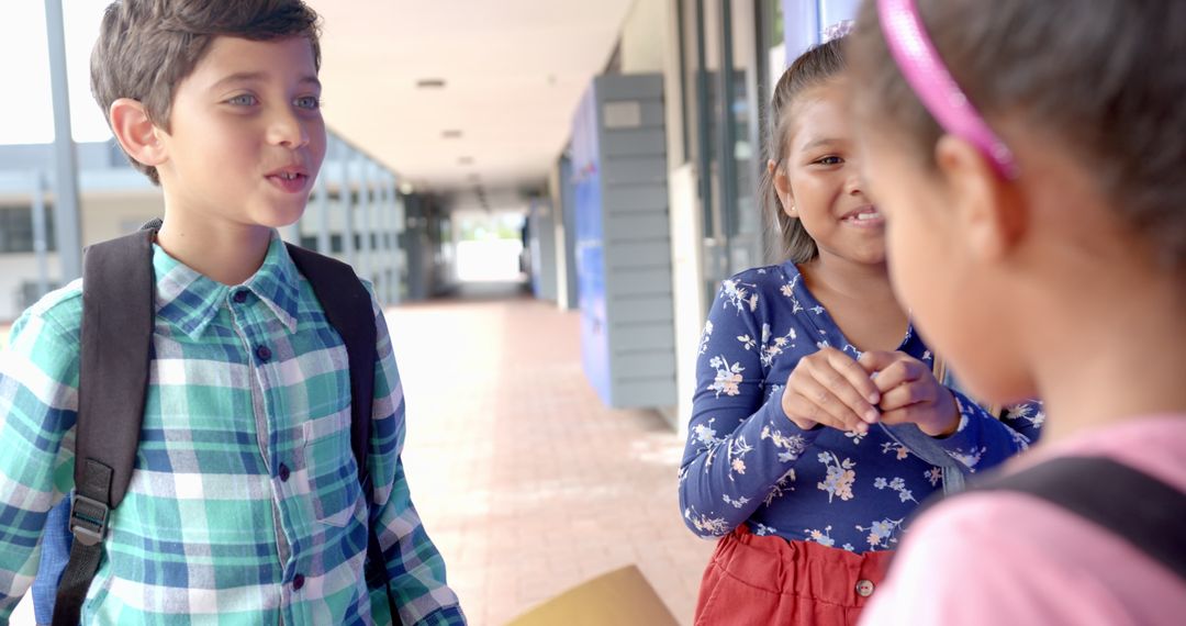 Happy diverse kids chatting in school hallway - Free Stock Photo ...