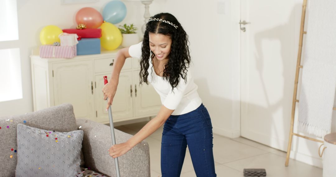 Woman Cleaning Living Room After Party with Broom - Free Stock Photo | Pikwizard