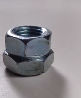 Close-up of Two Metal Hex Nuts Stacked Together from Pikwizard