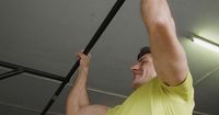 Determined Athlete Performing Intense Pull-Up Exercise - Download Free ...