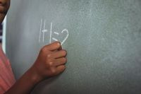 Student Writing Math Equation on Blackboard in Classroom - Download ...