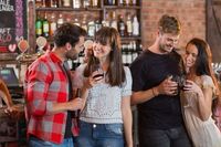 Young Couples Enjoying Drinks and Socializing in Bar - Download Free ...