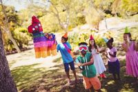 Children Playing with Colorful Pinata during Outdoor Birthday Party ...