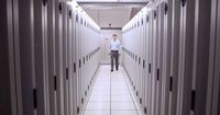 Man Walking in Modern Data Center - Download Free Image from Pikwizard