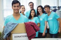 Diverse Volunteers Organizing Clothing Donations in Community Center ...