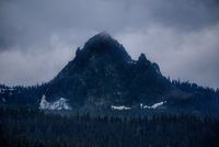 Dramatic Cloudy Mountain Peak with Snow in Foreboding Sky from Pikwizard