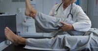 Healthcare Professional Examining Patient's Leg Flexibility in Clinic ...