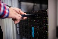 Technician Inserting Hard Disk into Blade Server in Data Center ...
