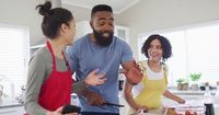 Happy multicultural family cooking together in modern kitchen from ...